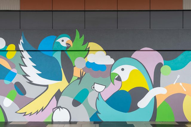 Artists apply the finishing touches to a series of murals at Stockland ...